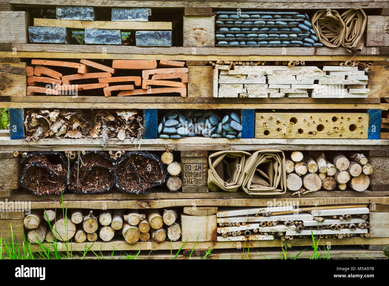 Close up of large bug house with several layers of different materials ...
