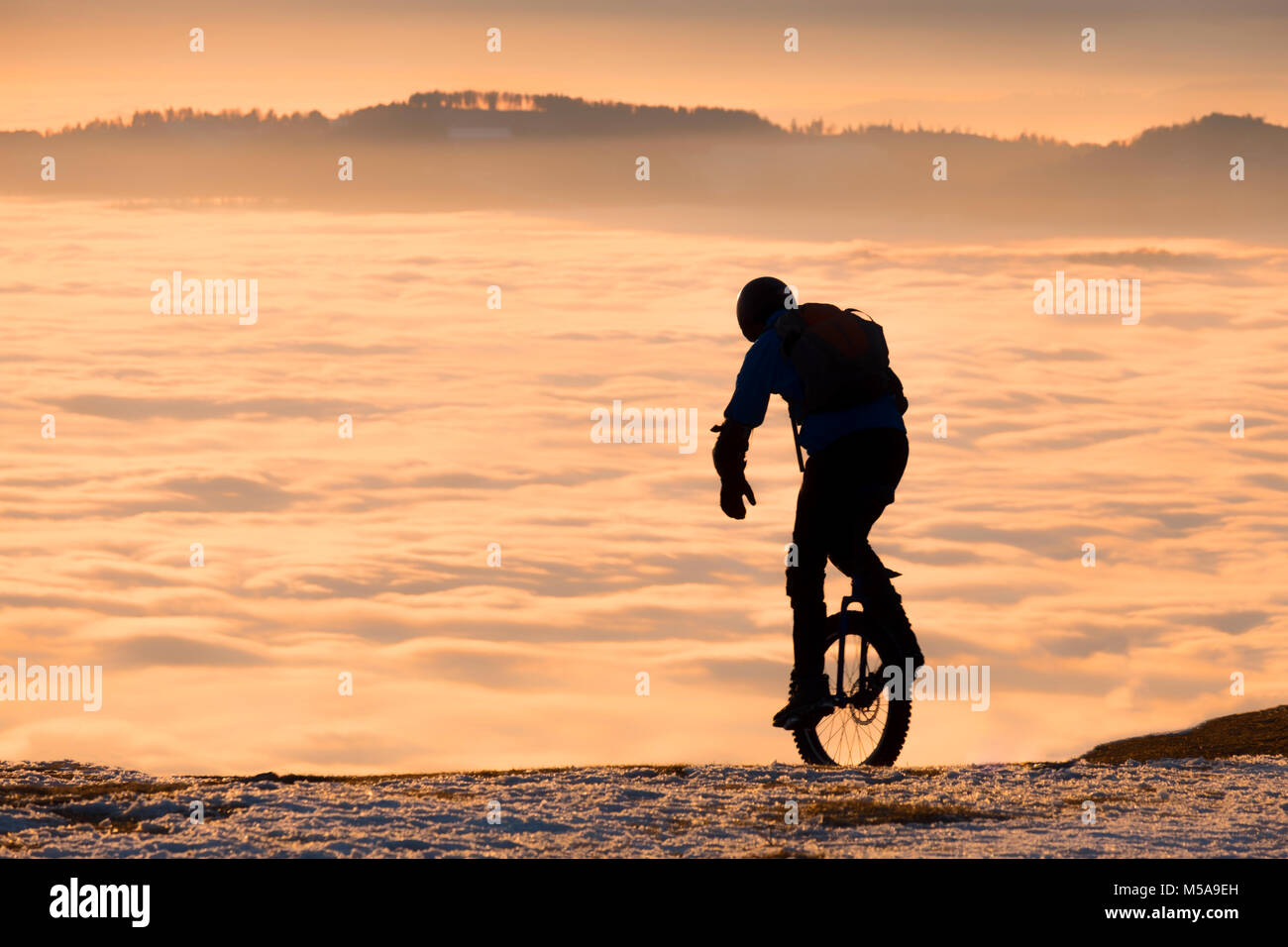Man riding unicycle hi-res stock photography and images - Alamy