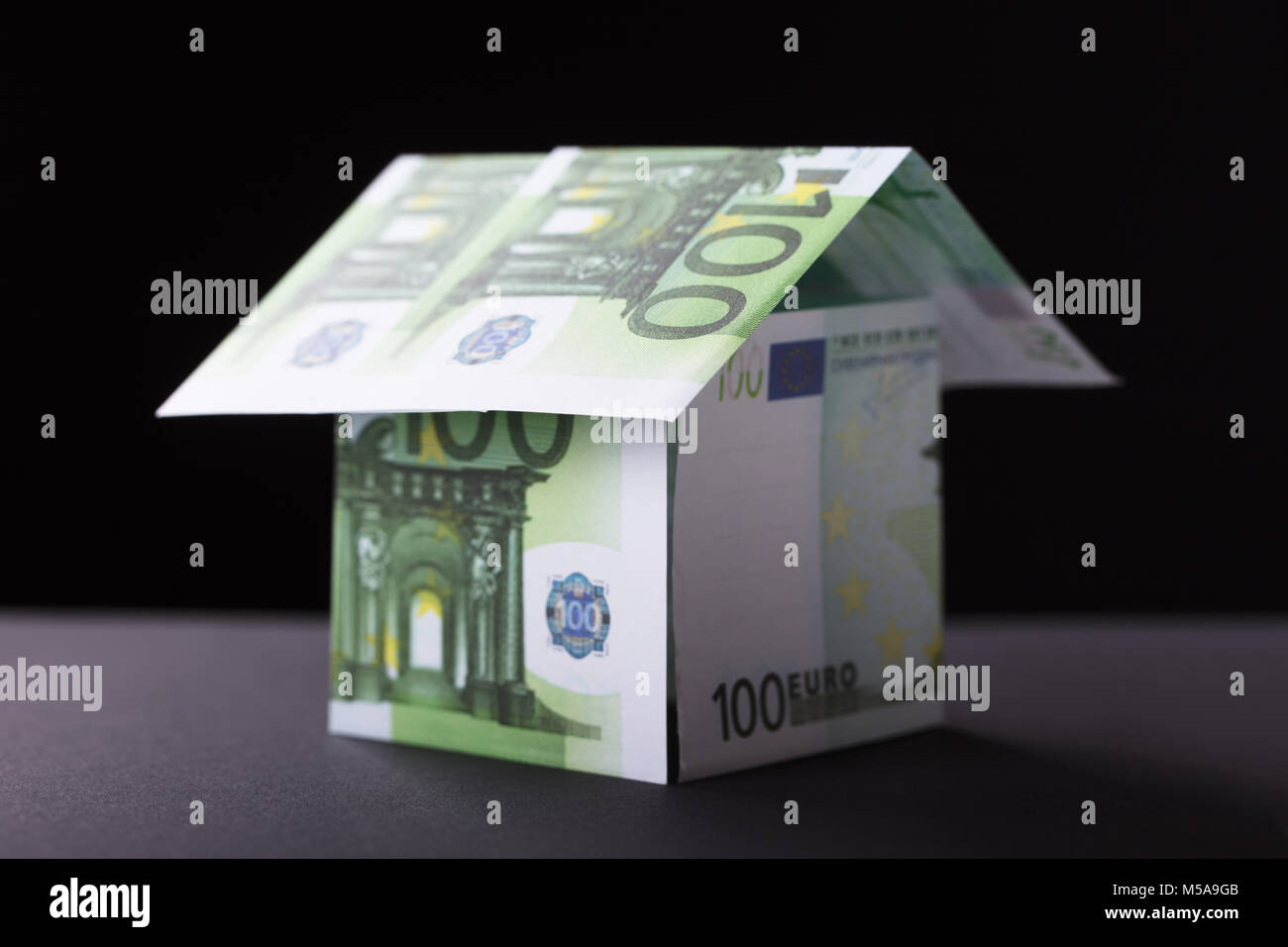 Close-up Of A House Made Up Of Banknote On Black Background Stock Photo ...