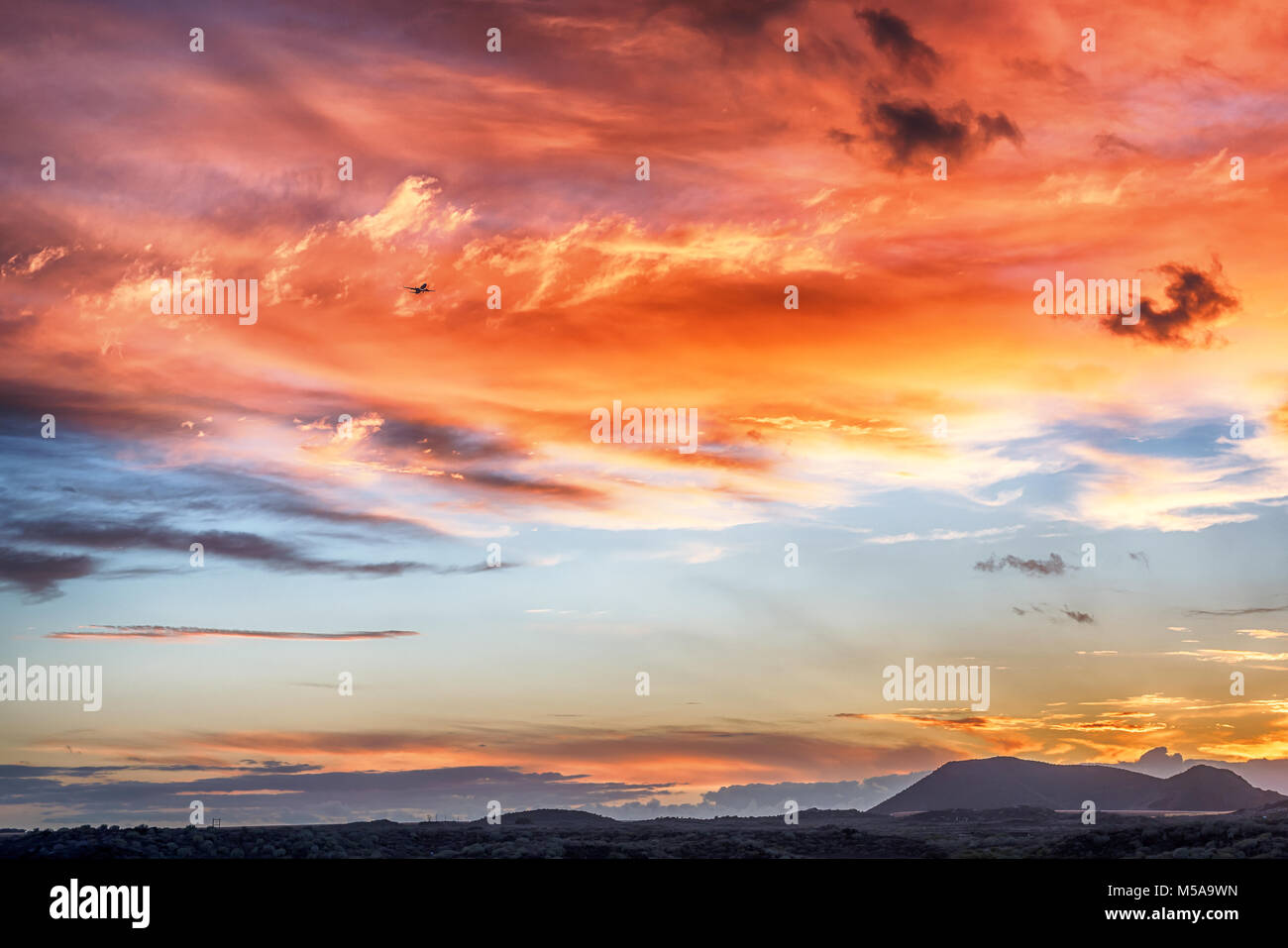 Plane at Sunset with Incredible Amazing Colors Stock Photo - Alamy
