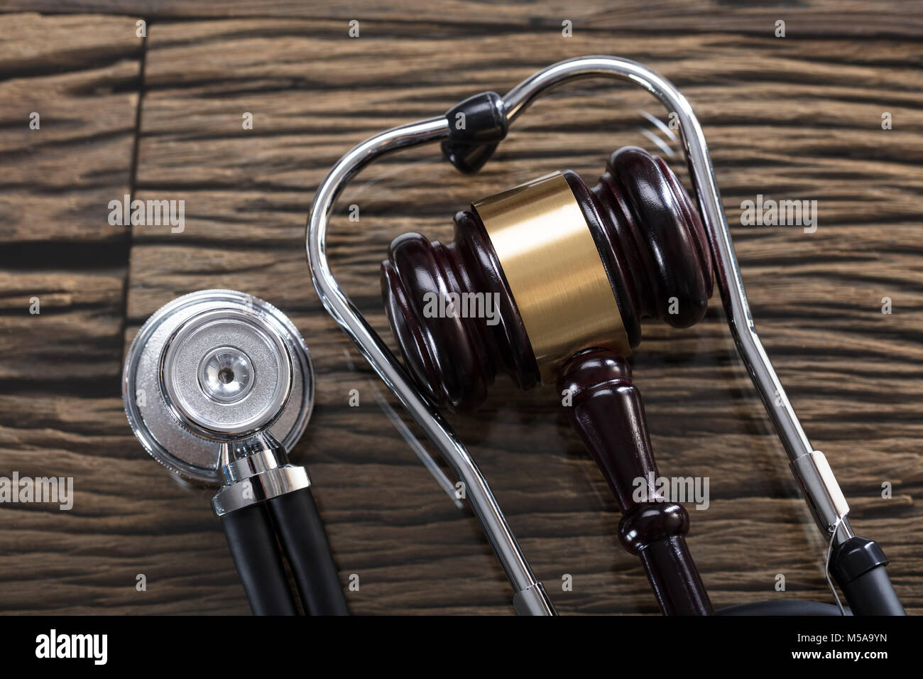 High Angle View Of Stethoscope And Gavel On Wooden Desk Stock Photo - Alamy