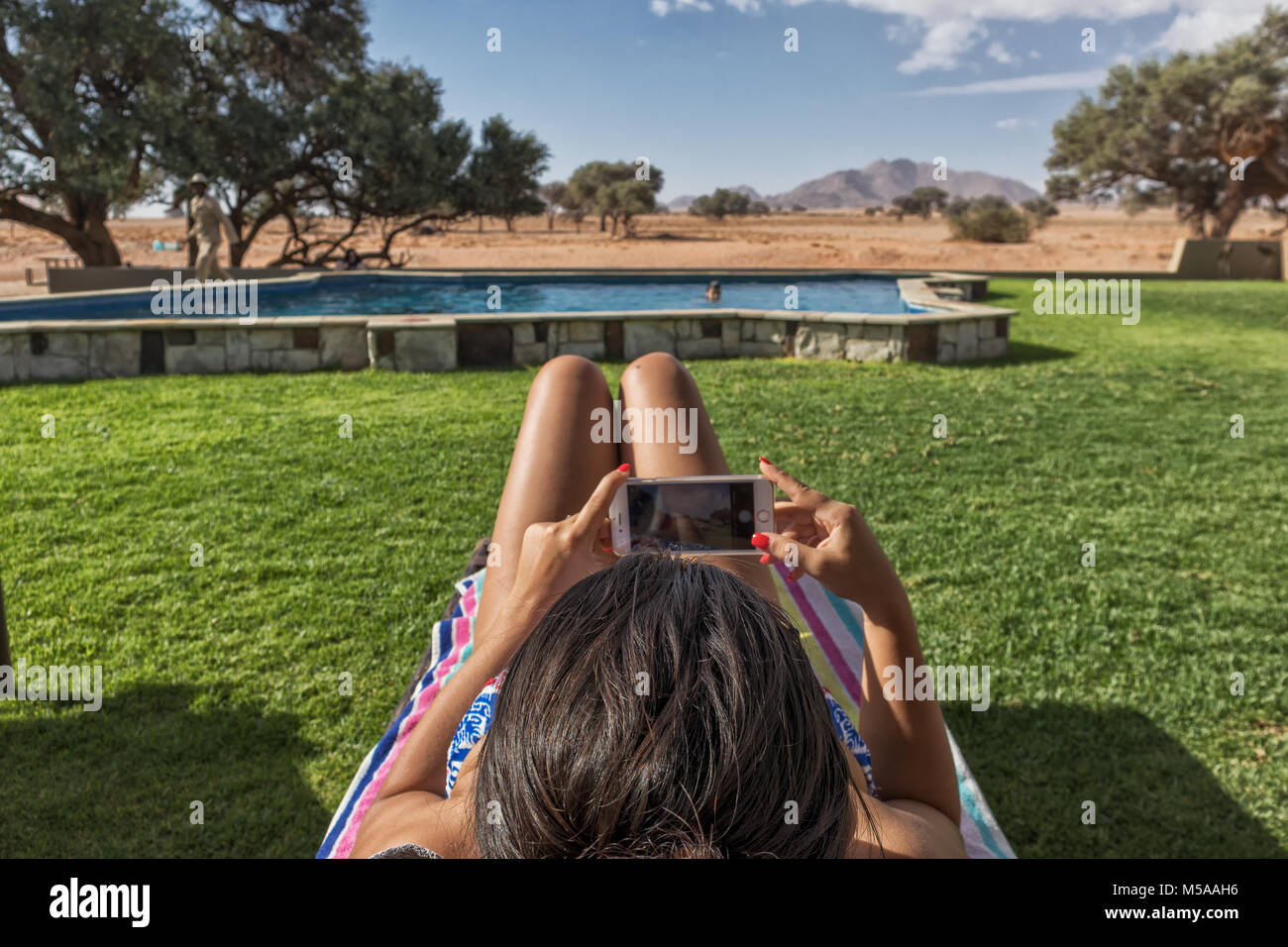 irl lying by the pool taking pictures with mobile phones Stock Photo ...