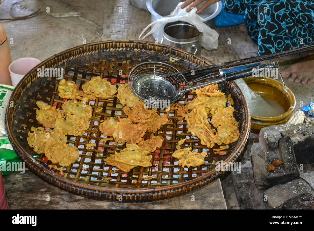 Deep fried food made in a small village in Myanmar Burma in a basket on ...