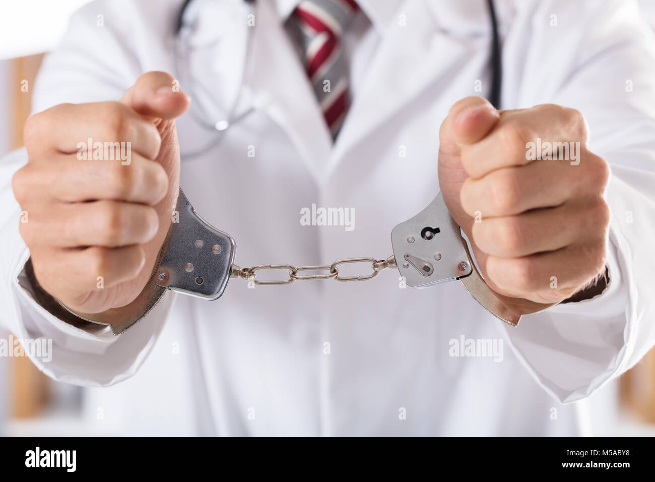 Close-up Of Arrested Doctor's Hand With Handcuffs Stock Photo - Alamy