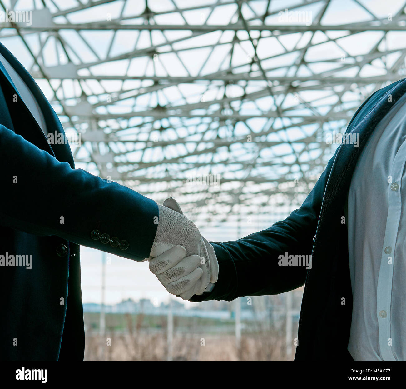 men shake hands at the construction site Stock Photo - Alamy