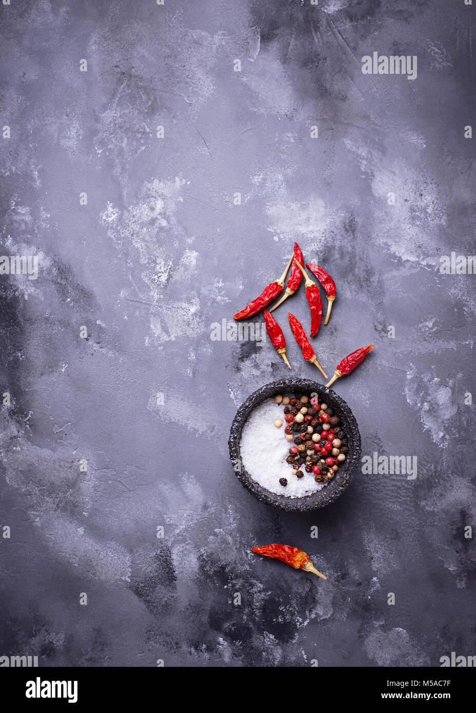 Mix of peppers and salt on gray background Stock Photo - Alamy