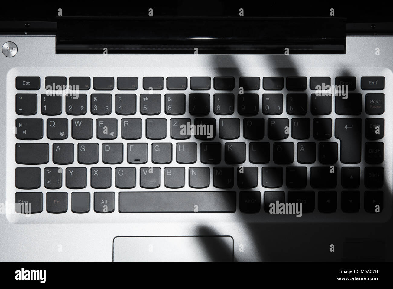 High Angle View Of Human Hand's Shadow Falling On Laptop Keypad Stock ...