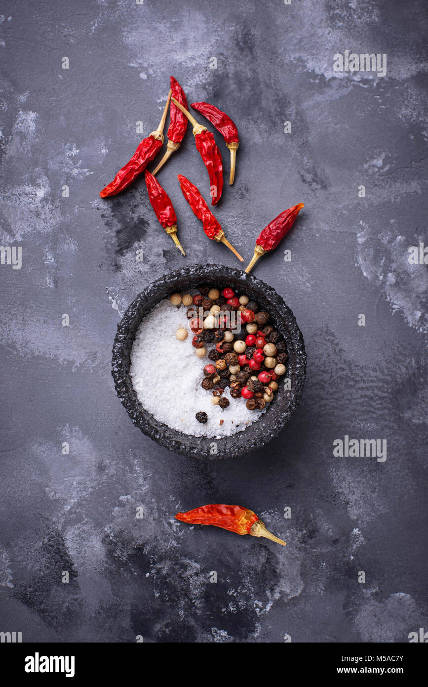 Mix of peppers and salt on gray background Stock Photo - Alamy
