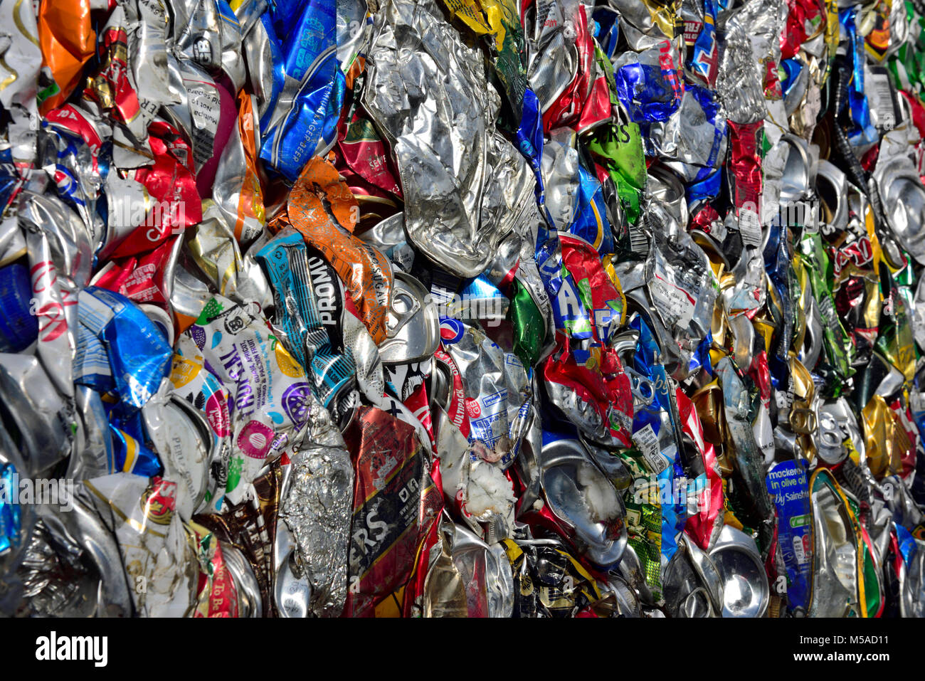 Metal cans crushed and bailed into large bundle at recycling plant to ...