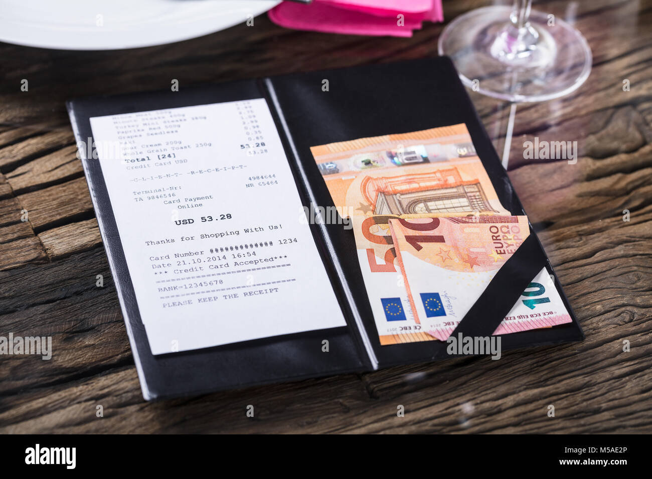 Elevated View Of Bill And Banknote On Wooden Desk Stock Photo - Alamy