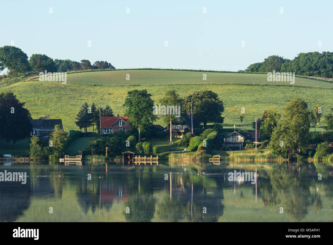 Houses located at Julsø opposite Laven Stock Photo - Alamy