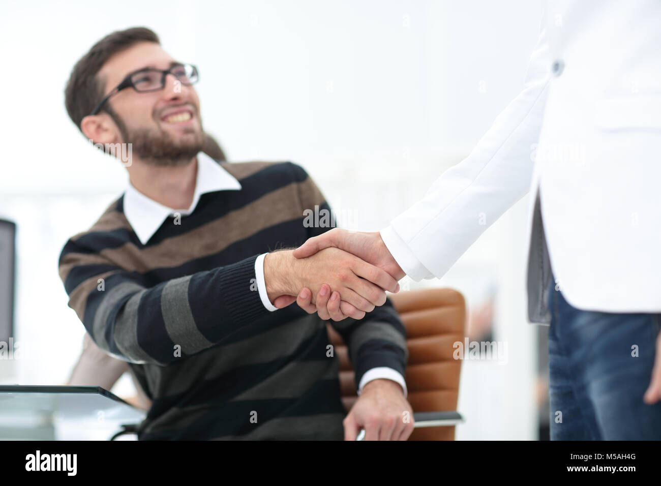 handshake between colleagues in the workplace Stock Photo - Alamy