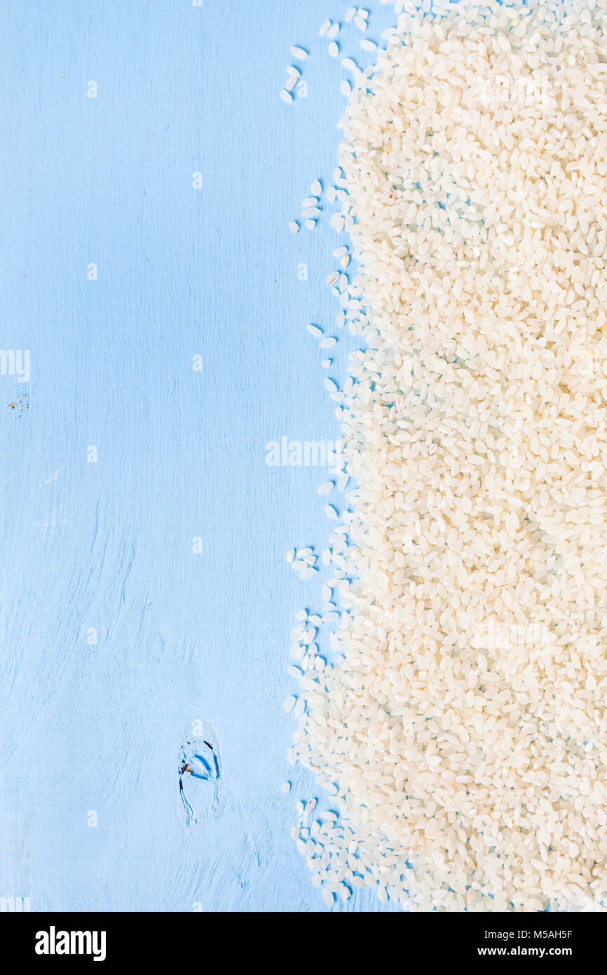 Raw rice close-up, blue background. Ingredient for a healthy diet Stock ...