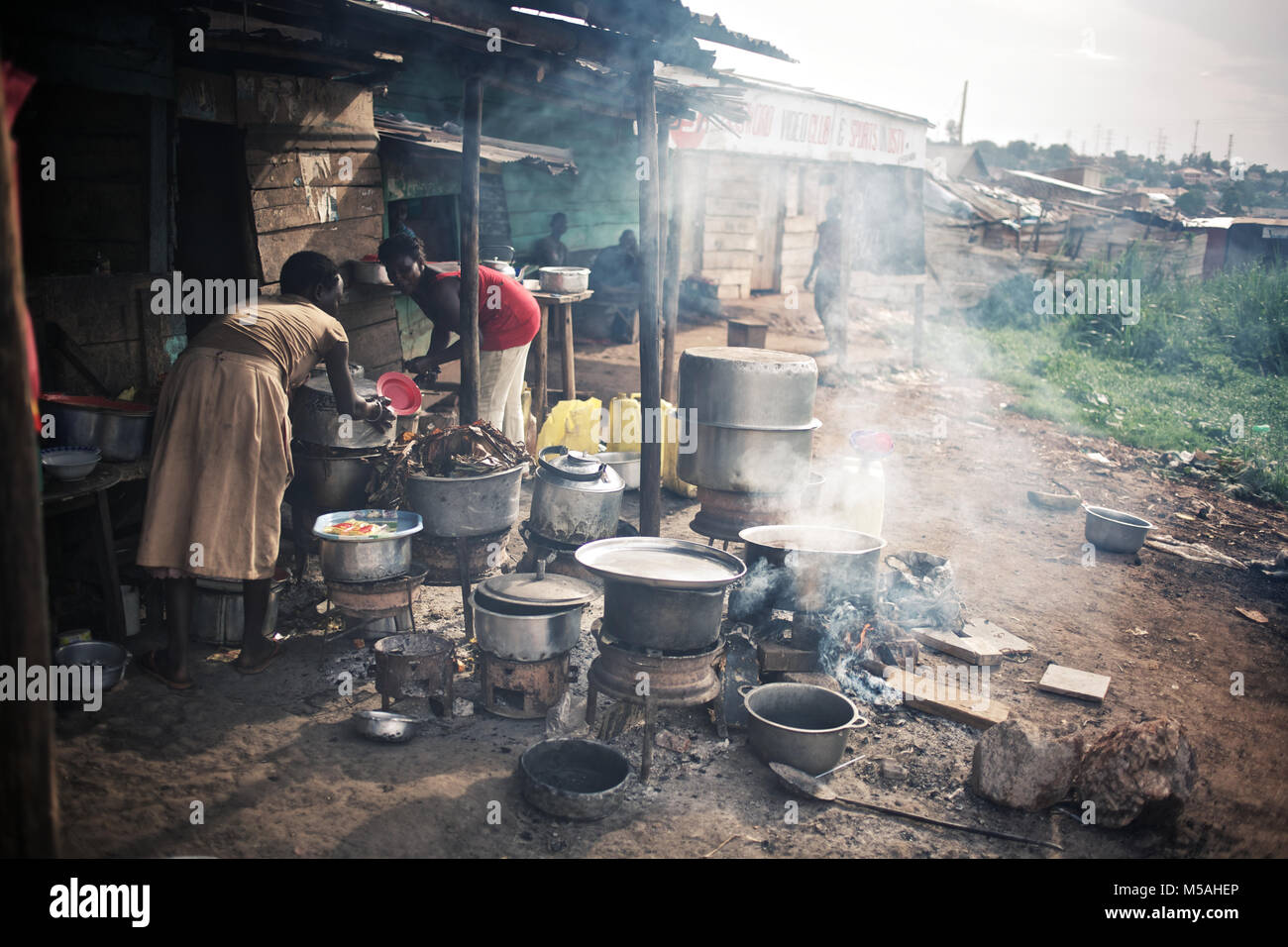Kampala, Uganda - September 26, 2011: African women are cooking outside ...