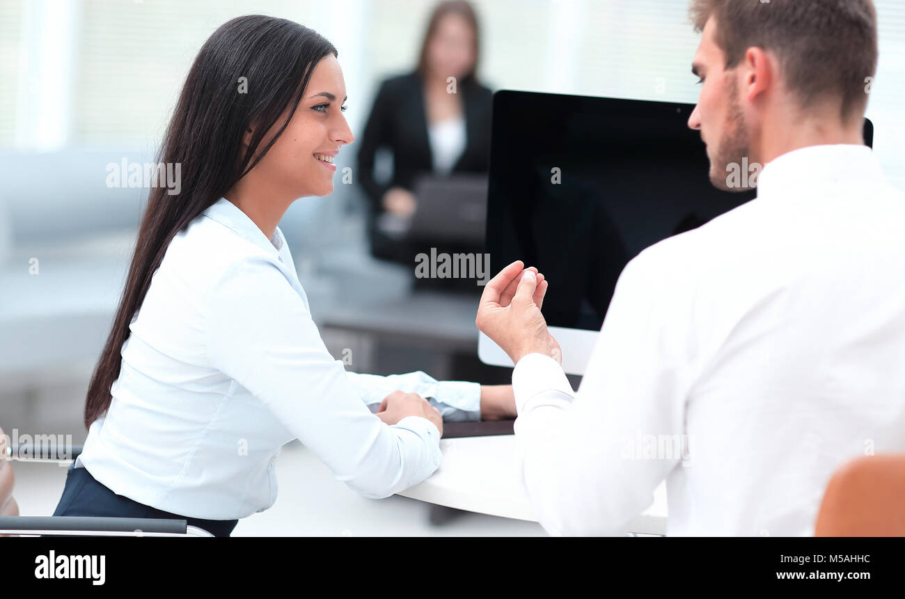 two successful employee talking sitting behind a Desk Stock Photo - Alamy