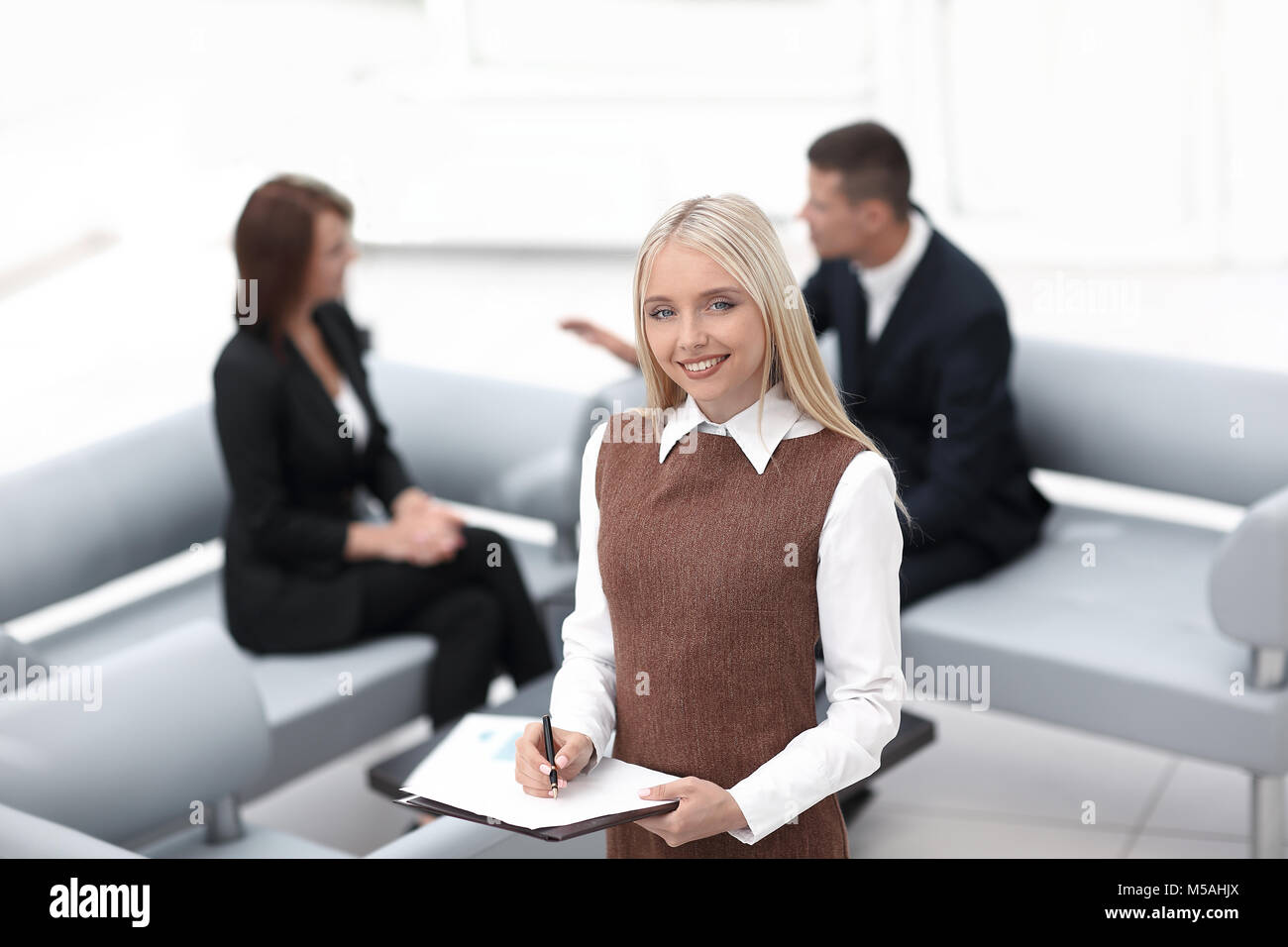 young woman assistant standing in the lobby of the modern office Stock ...