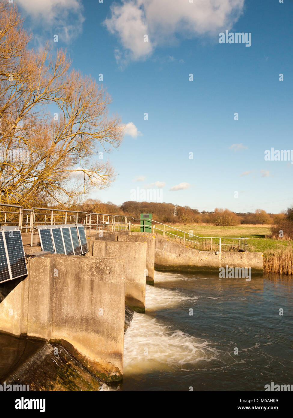 side view of river water damn bridge sluice outside country; essex ...