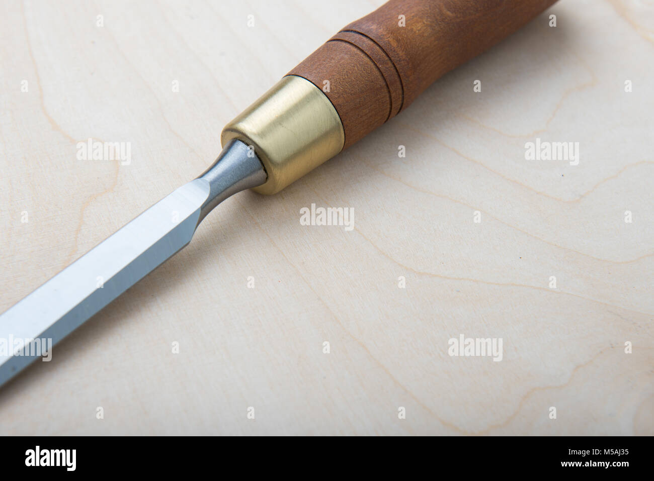 A professional chisel on a wooden background, with room for text Stock ...