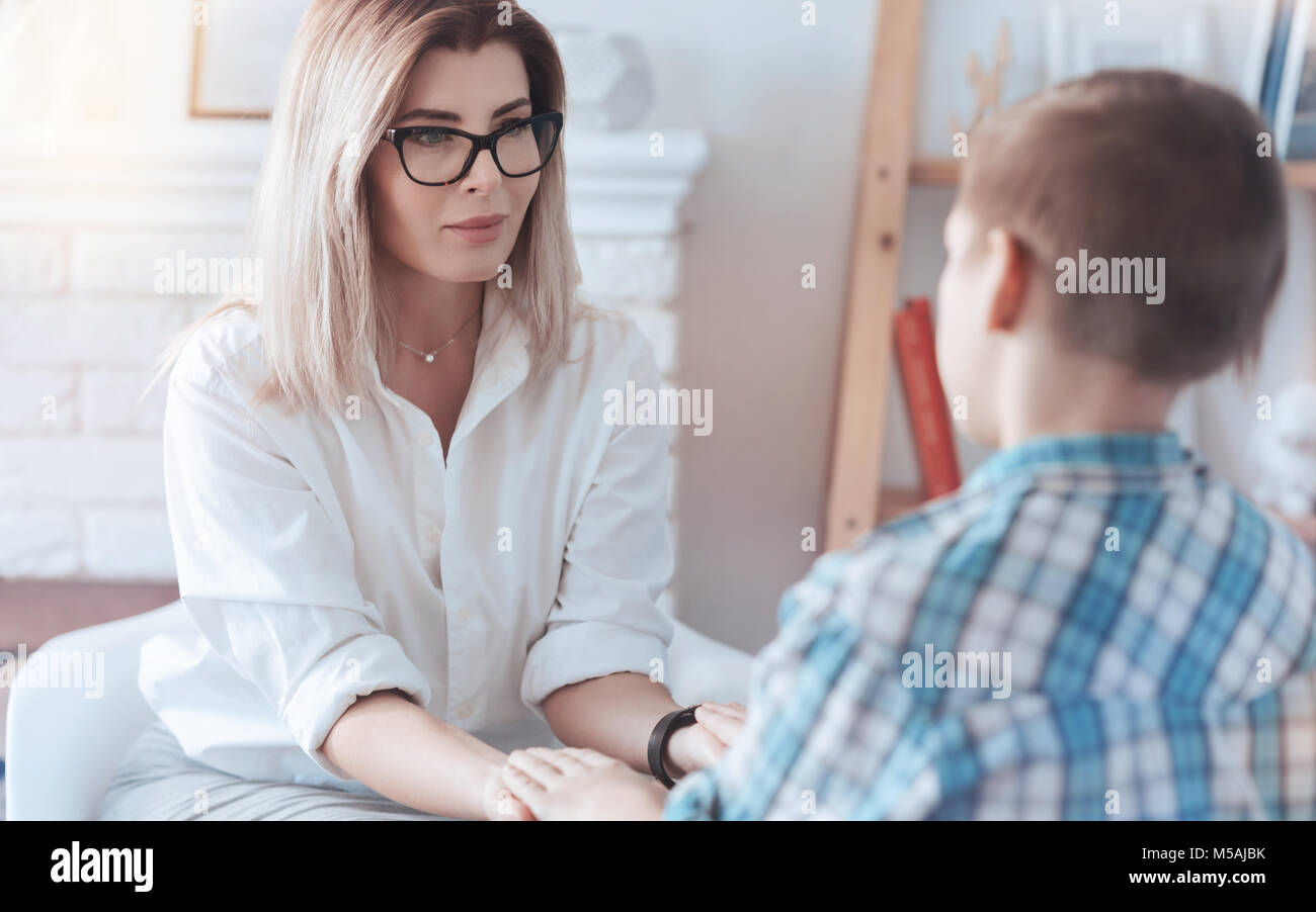 Smiling female psychologist building bridges with child patient Stock ...