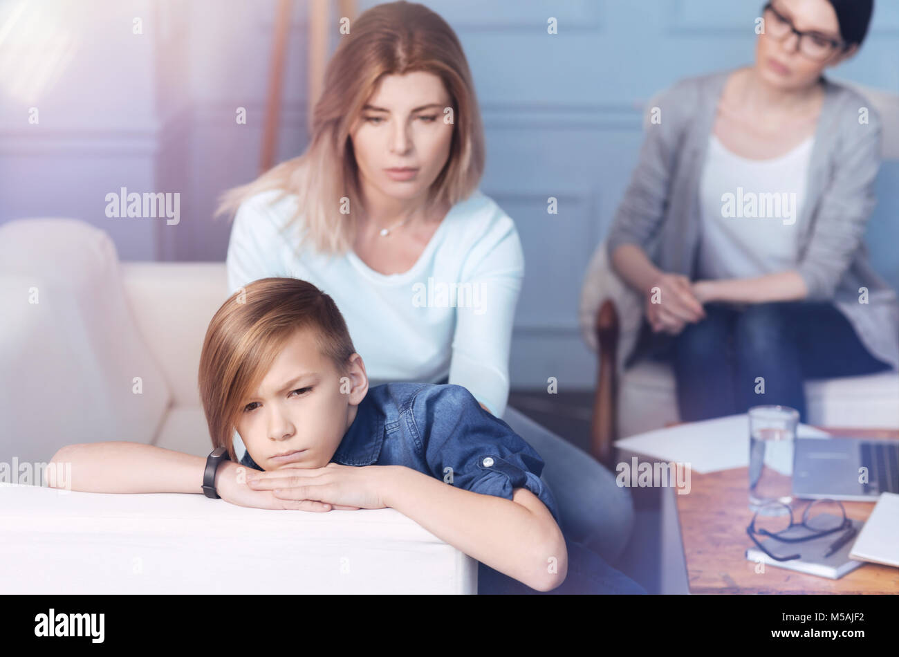 Out of humor boy ignoring mom during psychological seance Stock Photo ...