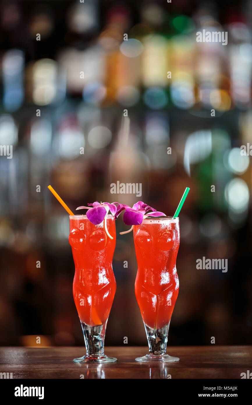 Composition with 2 red cocktails and orchid flowers on the blurred ...