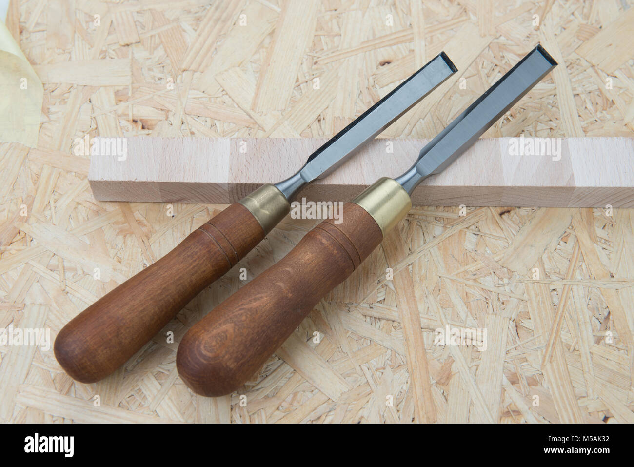 A professional chisel on a wooden background, with room for text Stock ...