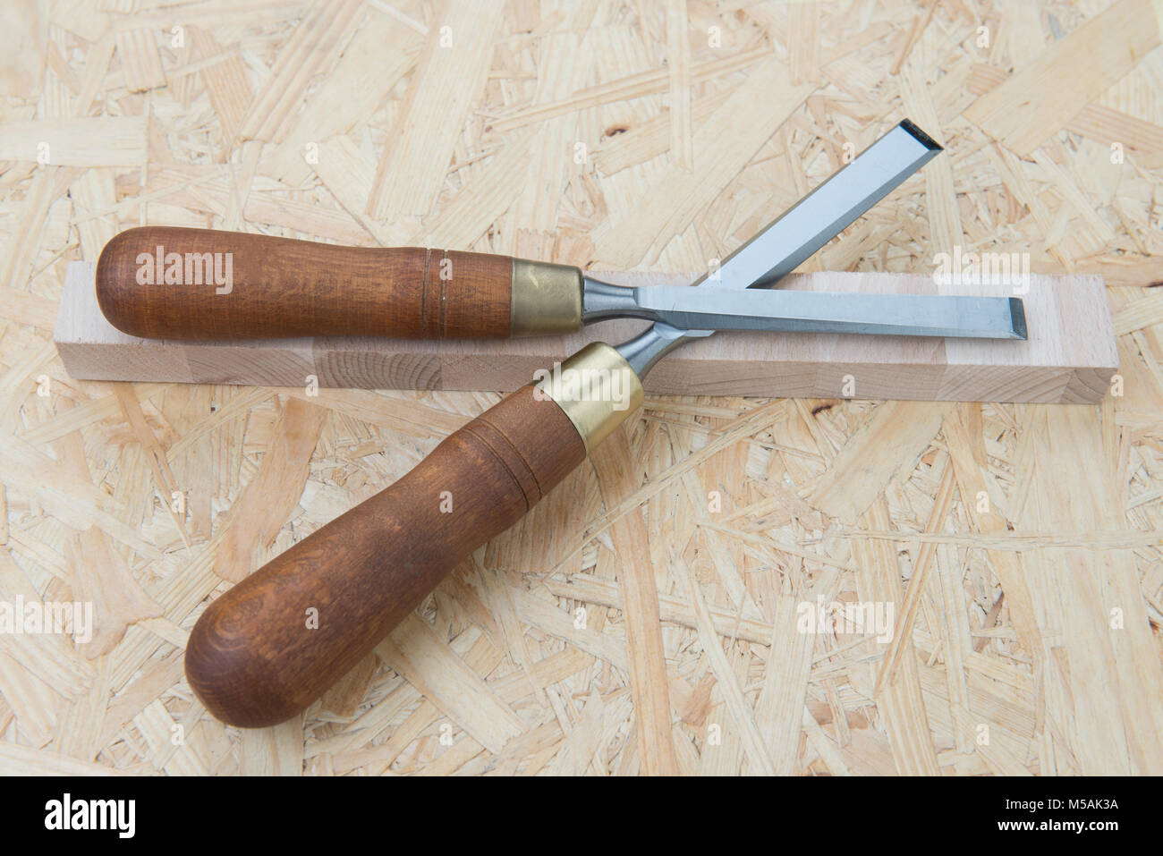 A professional chisel on a wooden background, with room for text Stock ...