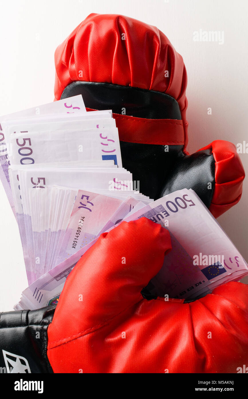 boxing for money, boxing glove with cash Stock Photo - Alamy