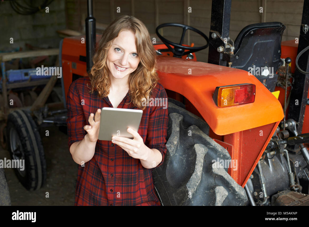 Portrait Of Female Agricultural Worker On Farm Using Digital Tablet ...