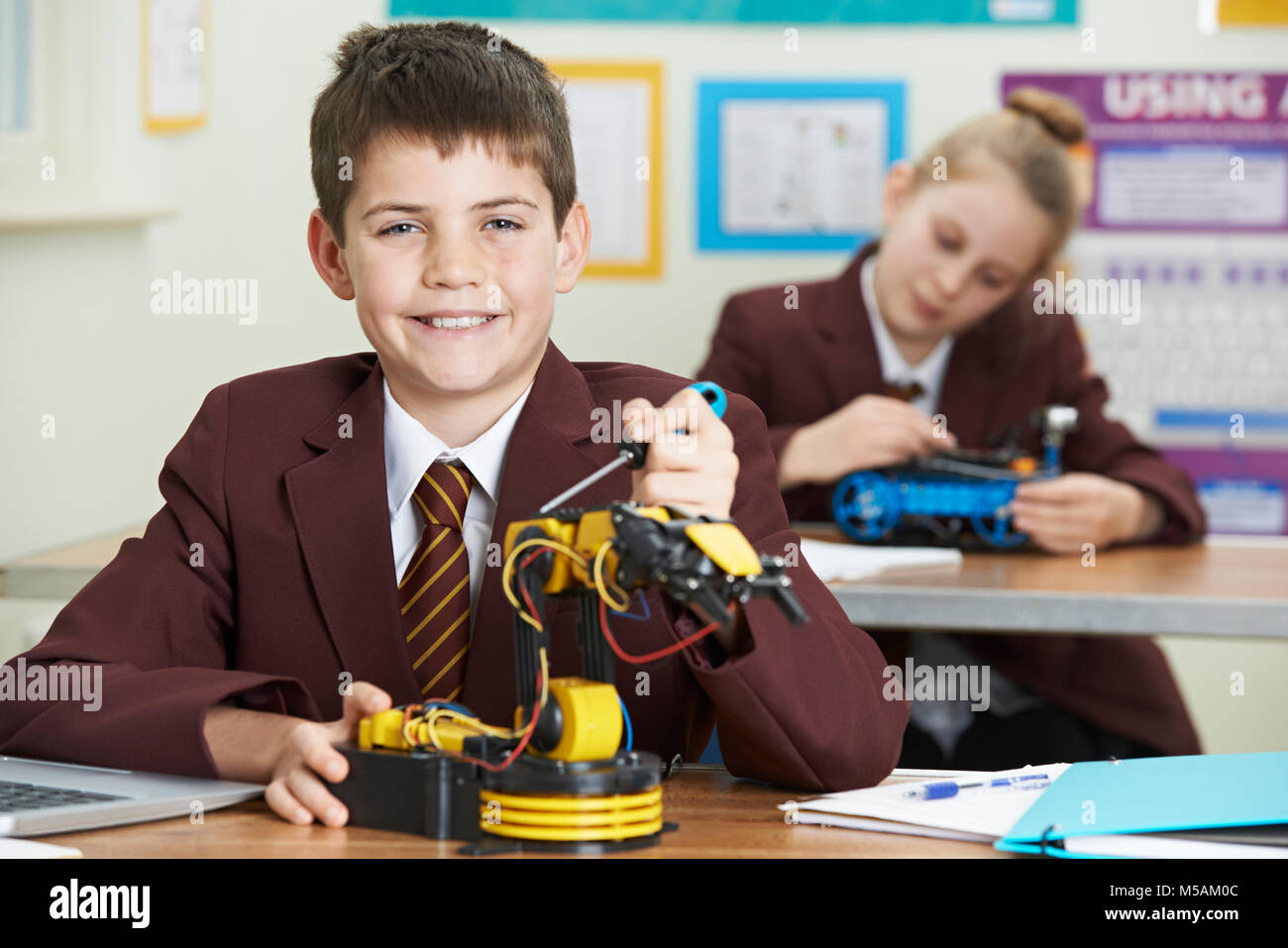Portrait Of Male Pupil In Science Lesson Studying Robotics Stock Photo ...