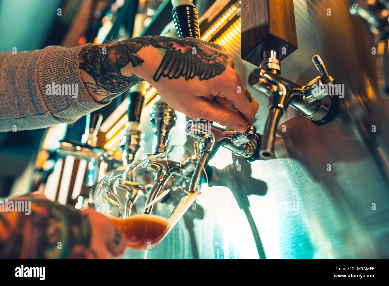 Pulling the tap hi-res stock photography and images - Alamy