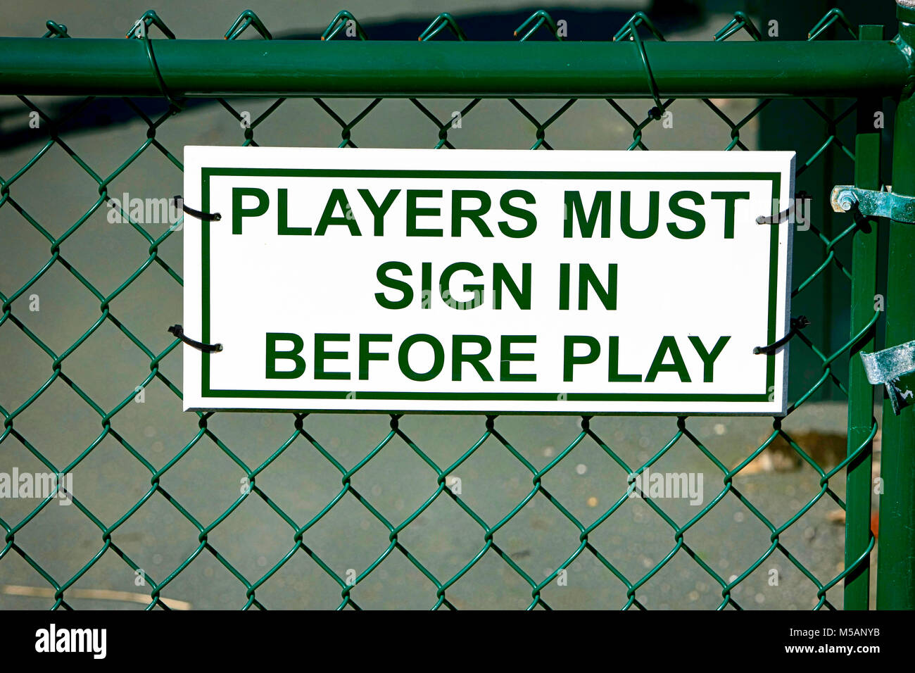 Players must sign in before play sign at a tennis club in Florida USA ...
