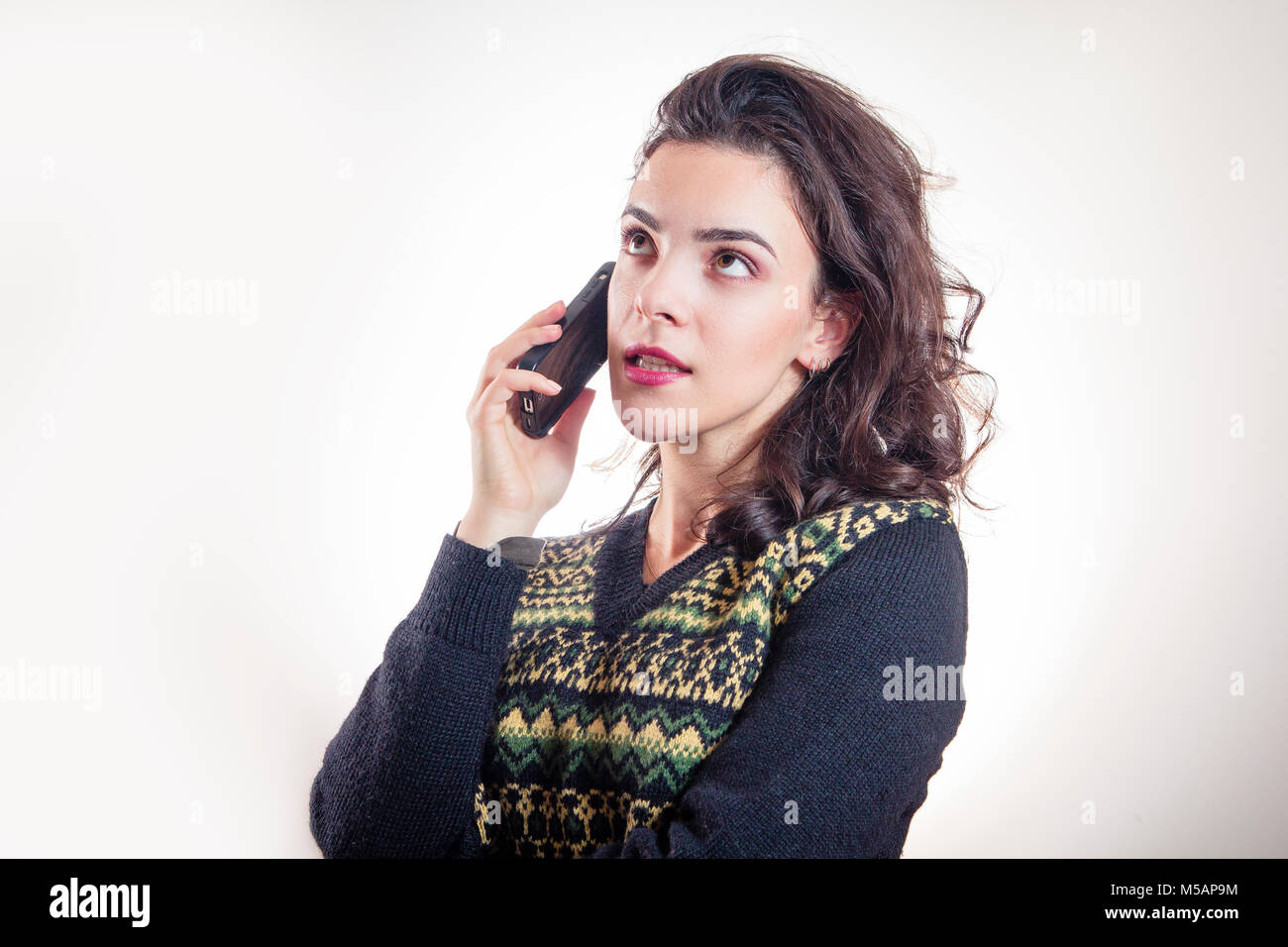 Woman having a boring conversation on her phone Stock Photo - Alamy