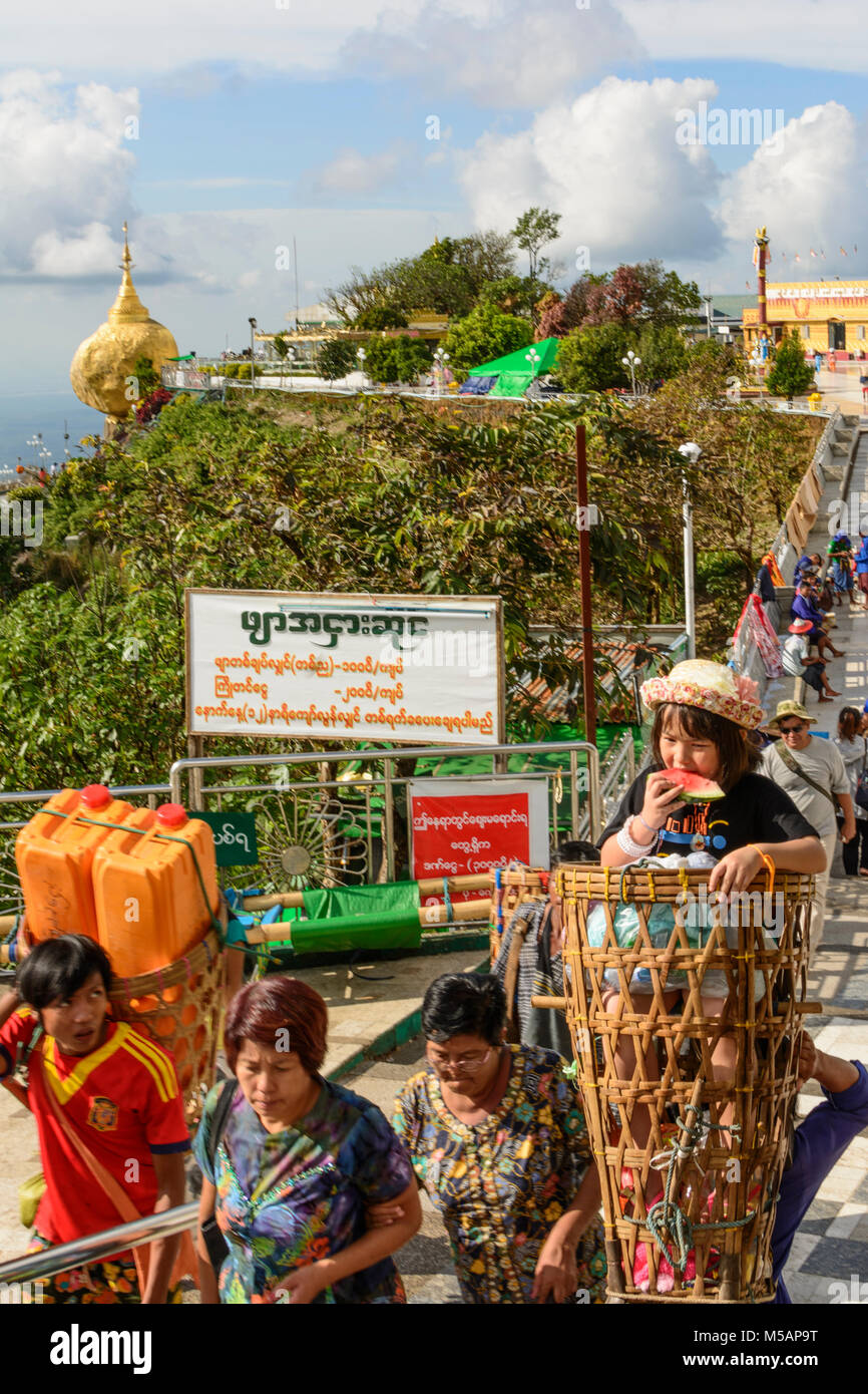 Kyaikto: mount Kyaiktiyo Pagoda (Golden Rock), porter, child in basket ...