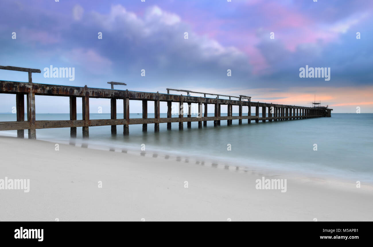 Old concrete bridge on the beach to the sea photo in sunset low ...