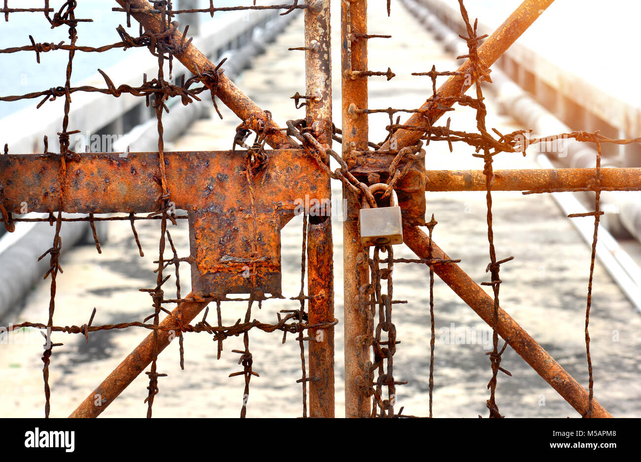 The rusty chains and old lock door in the block zone photo in sunset ...
