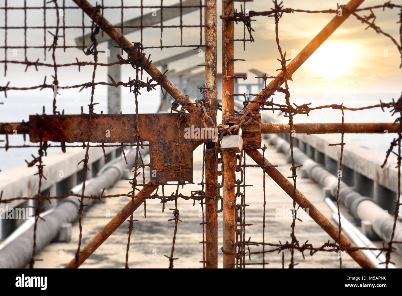 The rusty chains and old lock door in the block zone photo in sunset ...