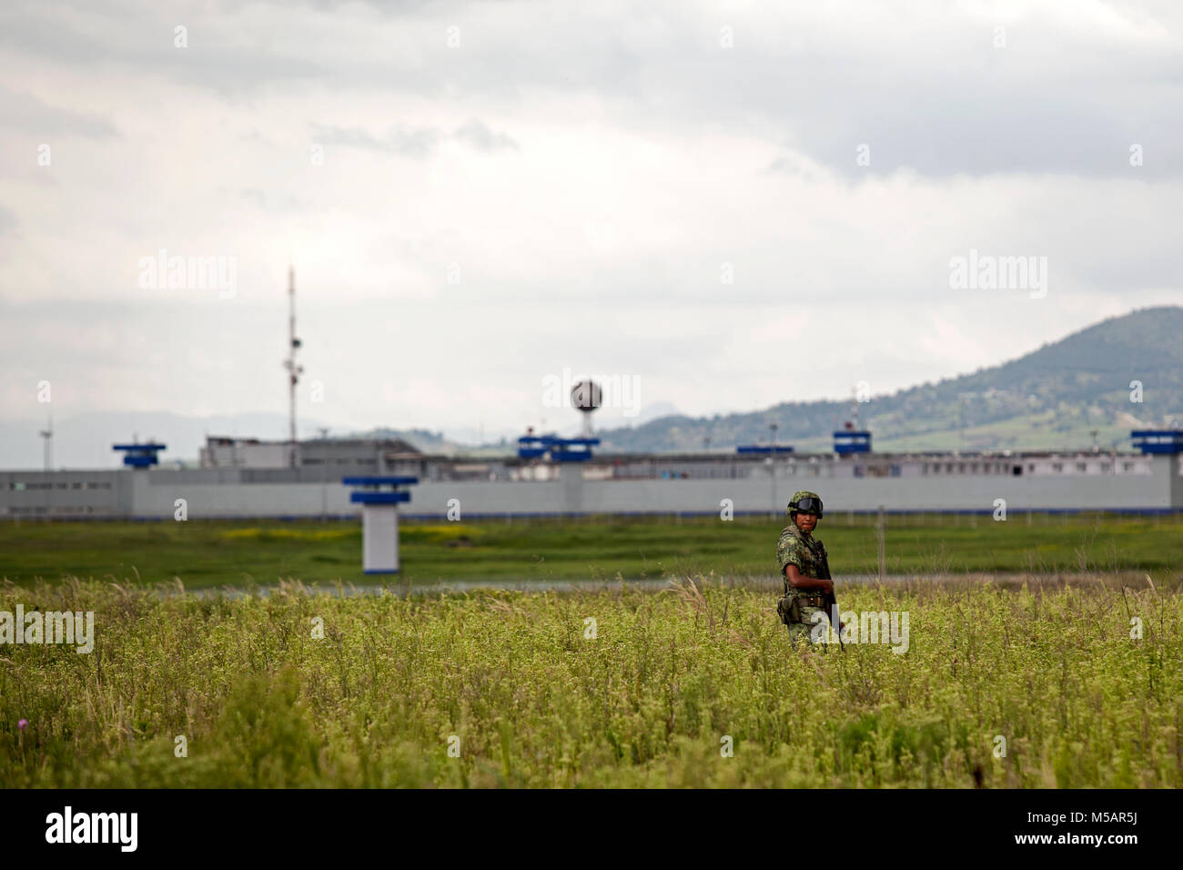 A Mexican Army soldier guards a small farm house that was used by Joaquin "El Chapo" Guzman to ...