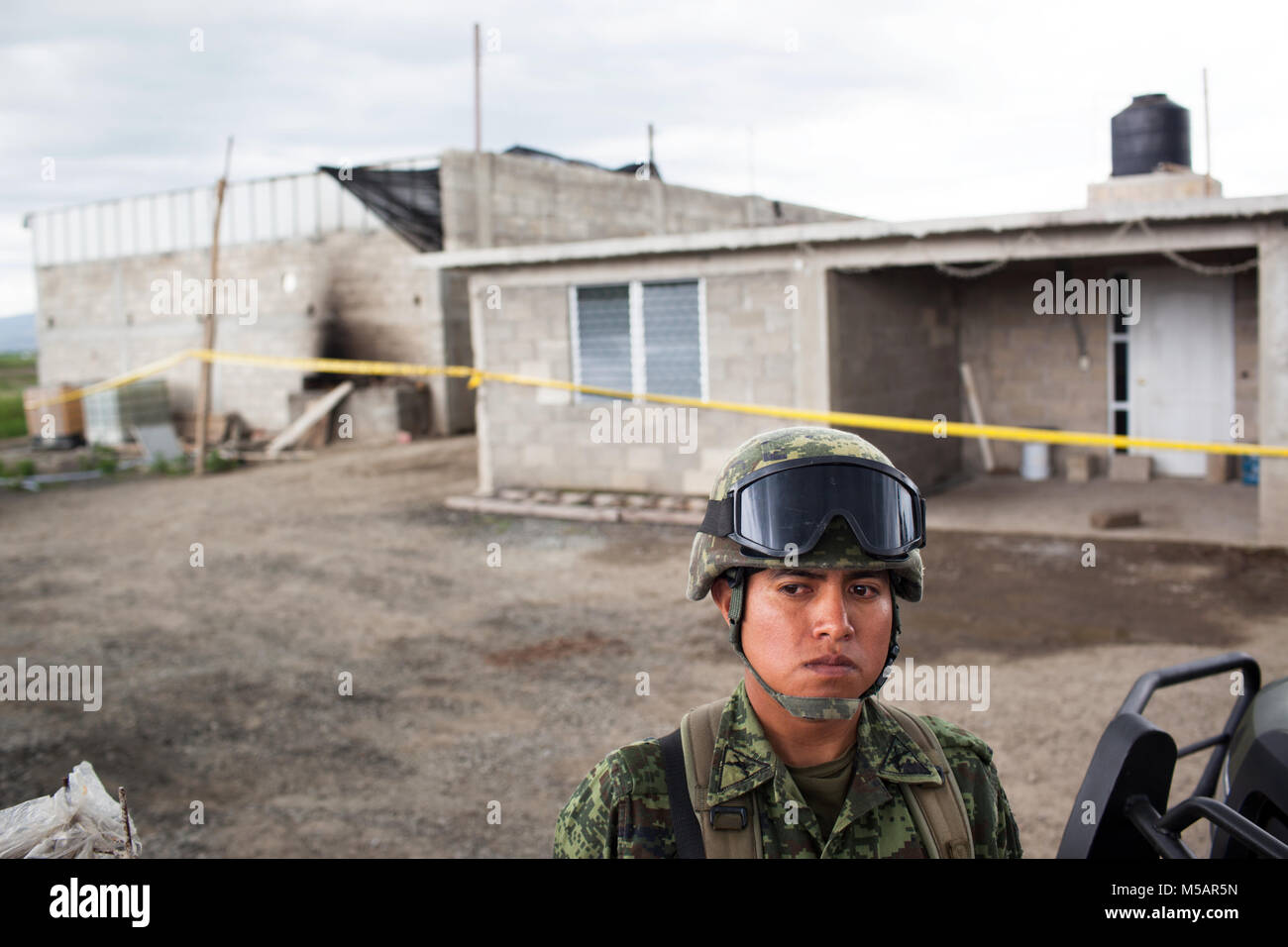 A Mexican Army soldier guards a small farm house that was used by Joaquin "El Chapo" Guzman to ...