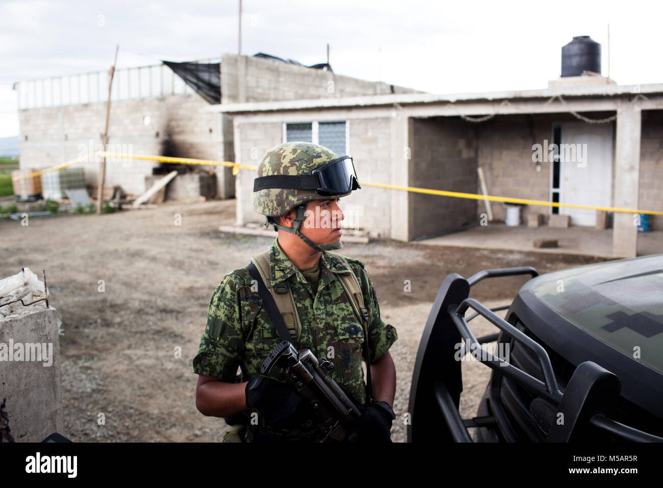 A Mexican Army soldier guards a small farm house that was used by Joaquin "El Chapo" Guzman to ...