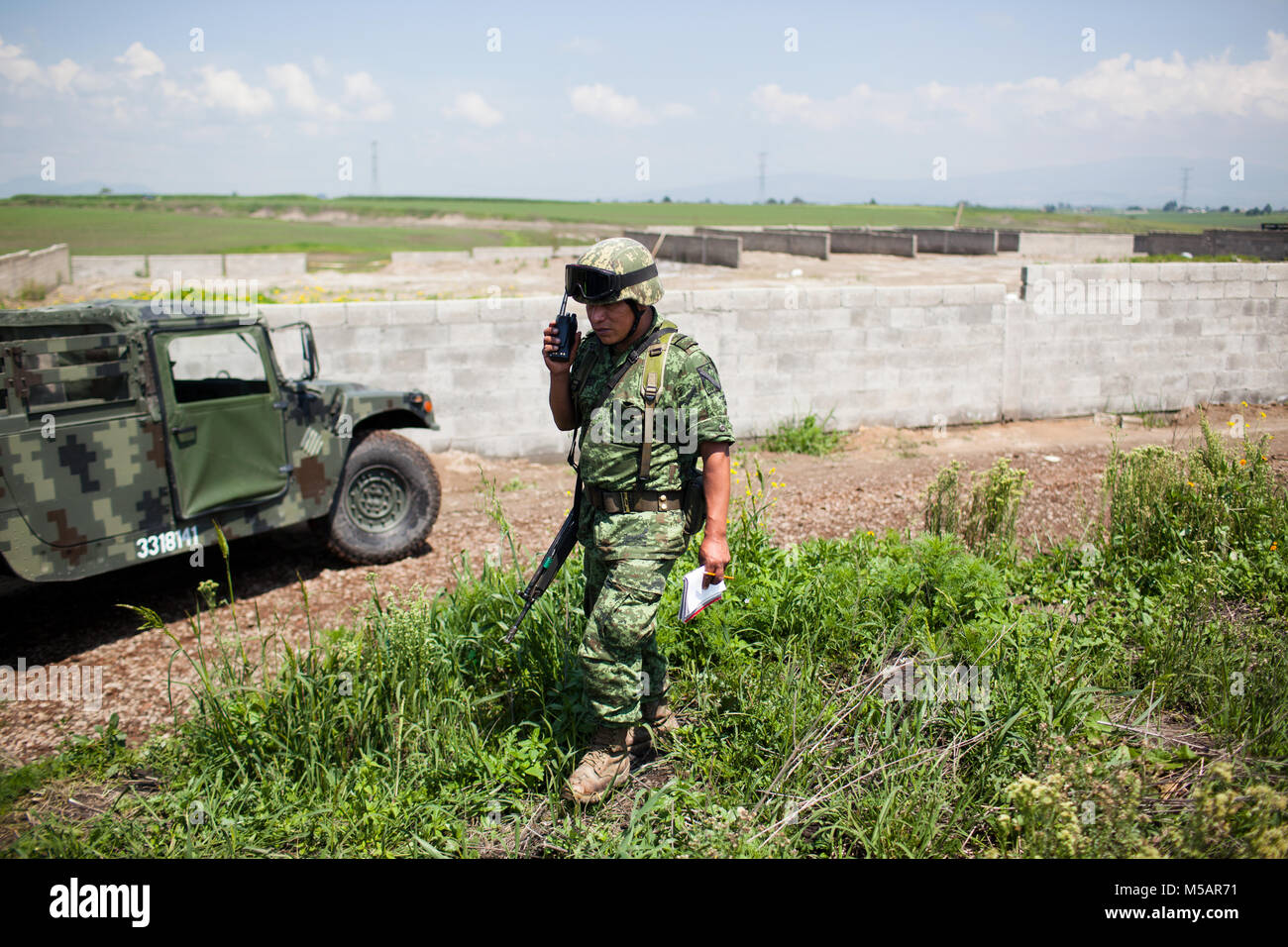 A Mexican Army soldier guards a small farm house that was used by Joaquin "El Chapo" Guzman to ...