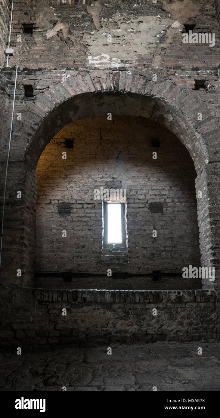 Stone interior with window of an old steeple crypt, located inside an ...