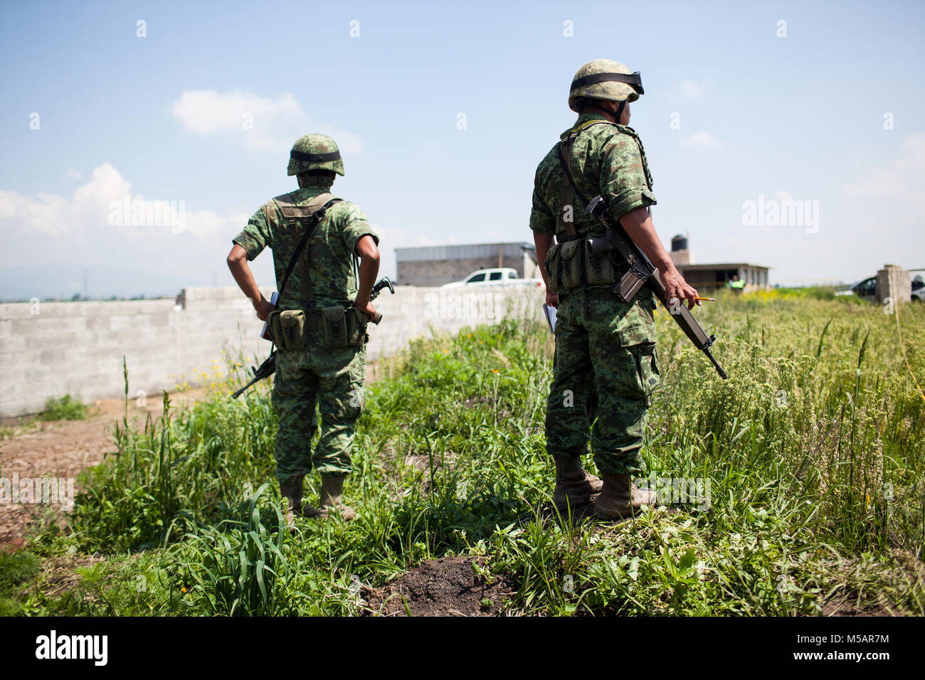 Mexican Army soldiers guard a small farm house that was used by Joaquin "El Chapo" Guzman to ...