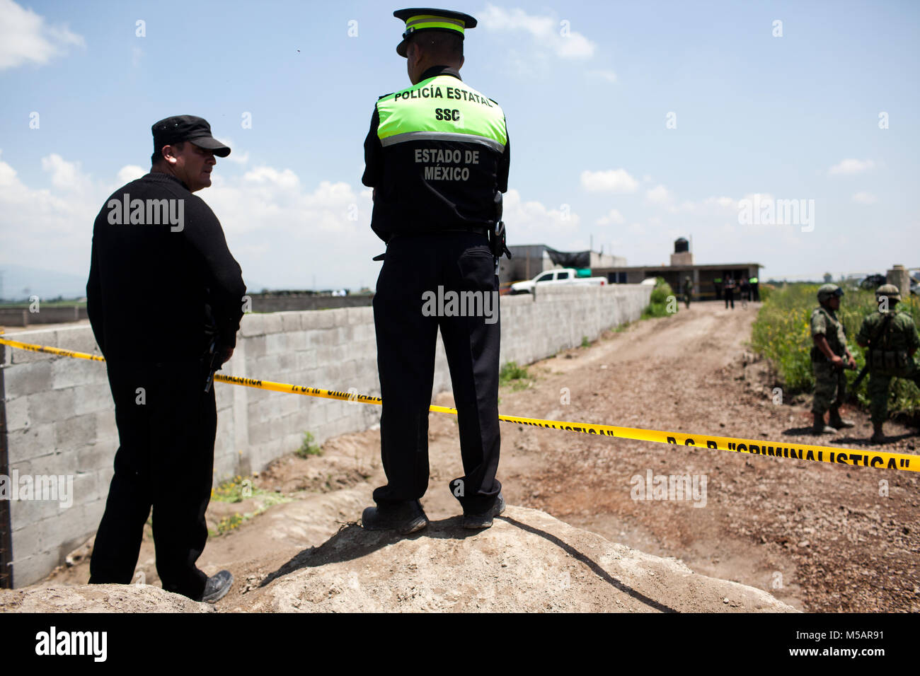 A police officer guards a small farm house that was used by Joaquin "El Chapo" Guzman to escape ...