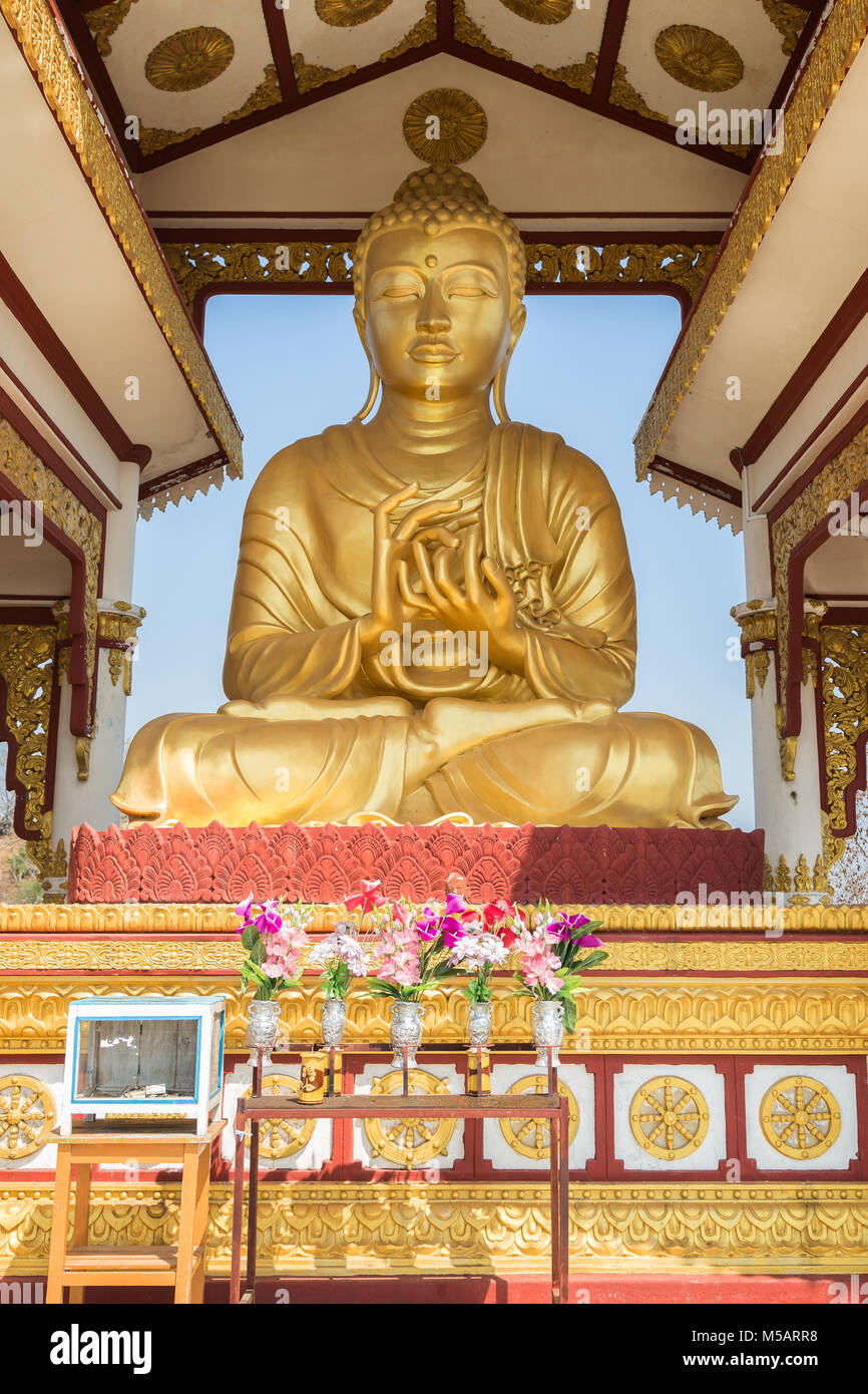 Front view of a golden statue of Buddha in lotus position on the ...
