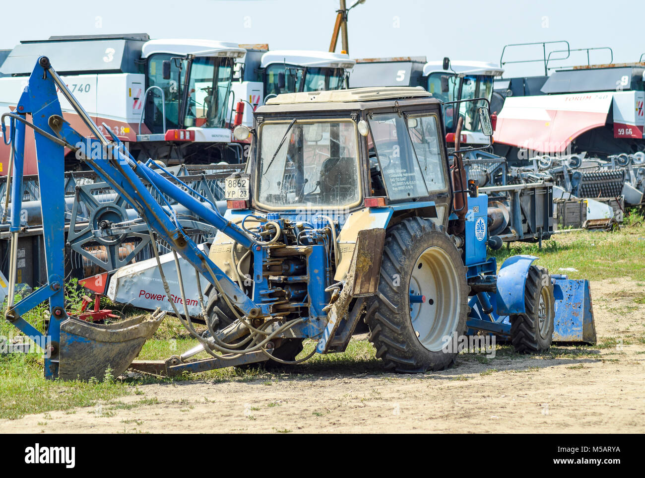 Russia, Temryuk - 15 July 2015: Tractor, standing in a row. Agricultural machinery. Parking of ...