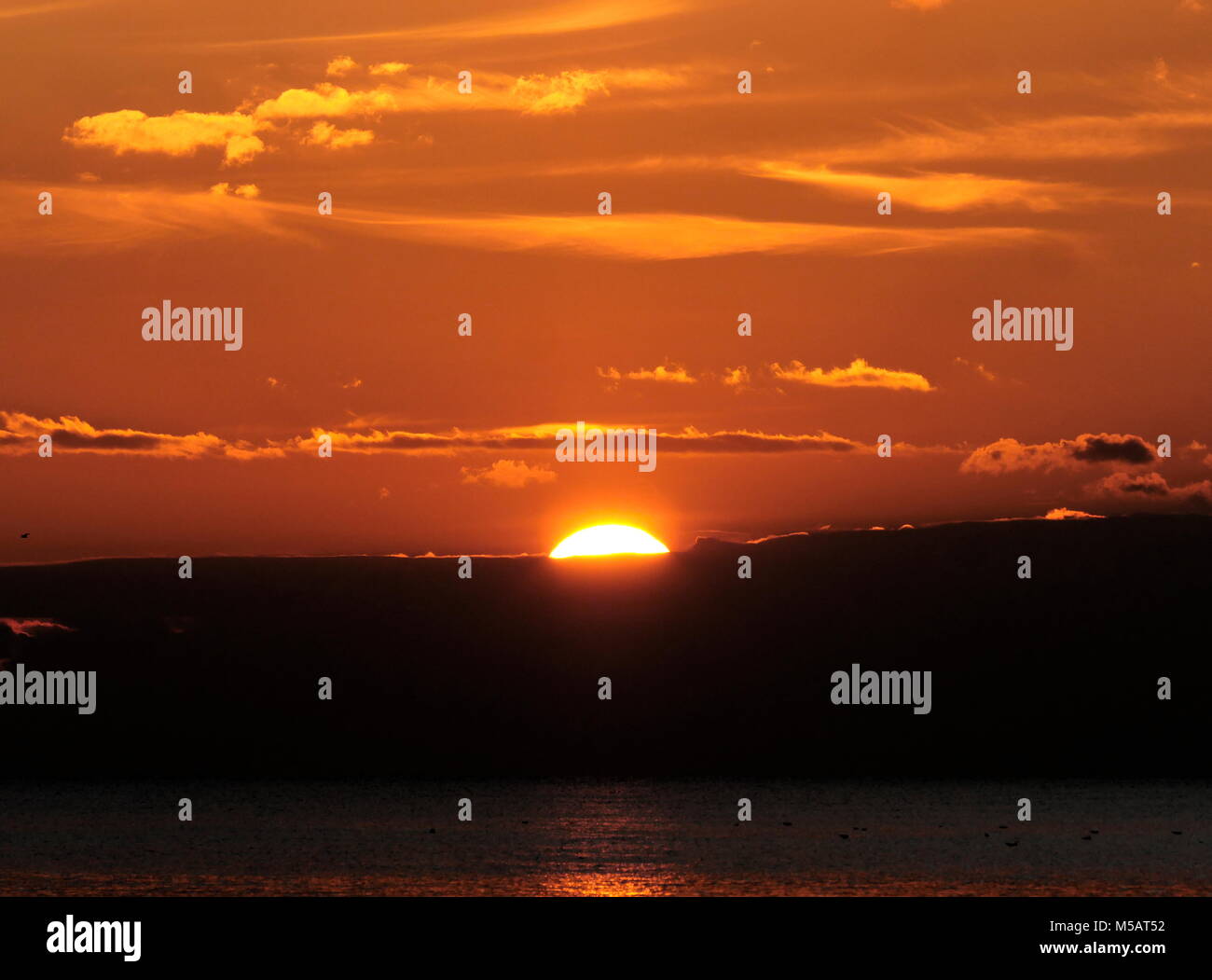 Fiery sunset through storm clouds hi-res stock photography and images ...