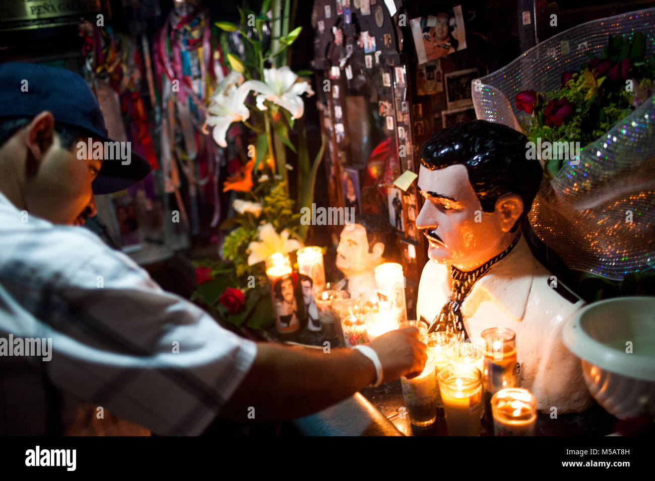 A man lights a candle in the shrine of Jesœs Malverde in Culiac‡n ...