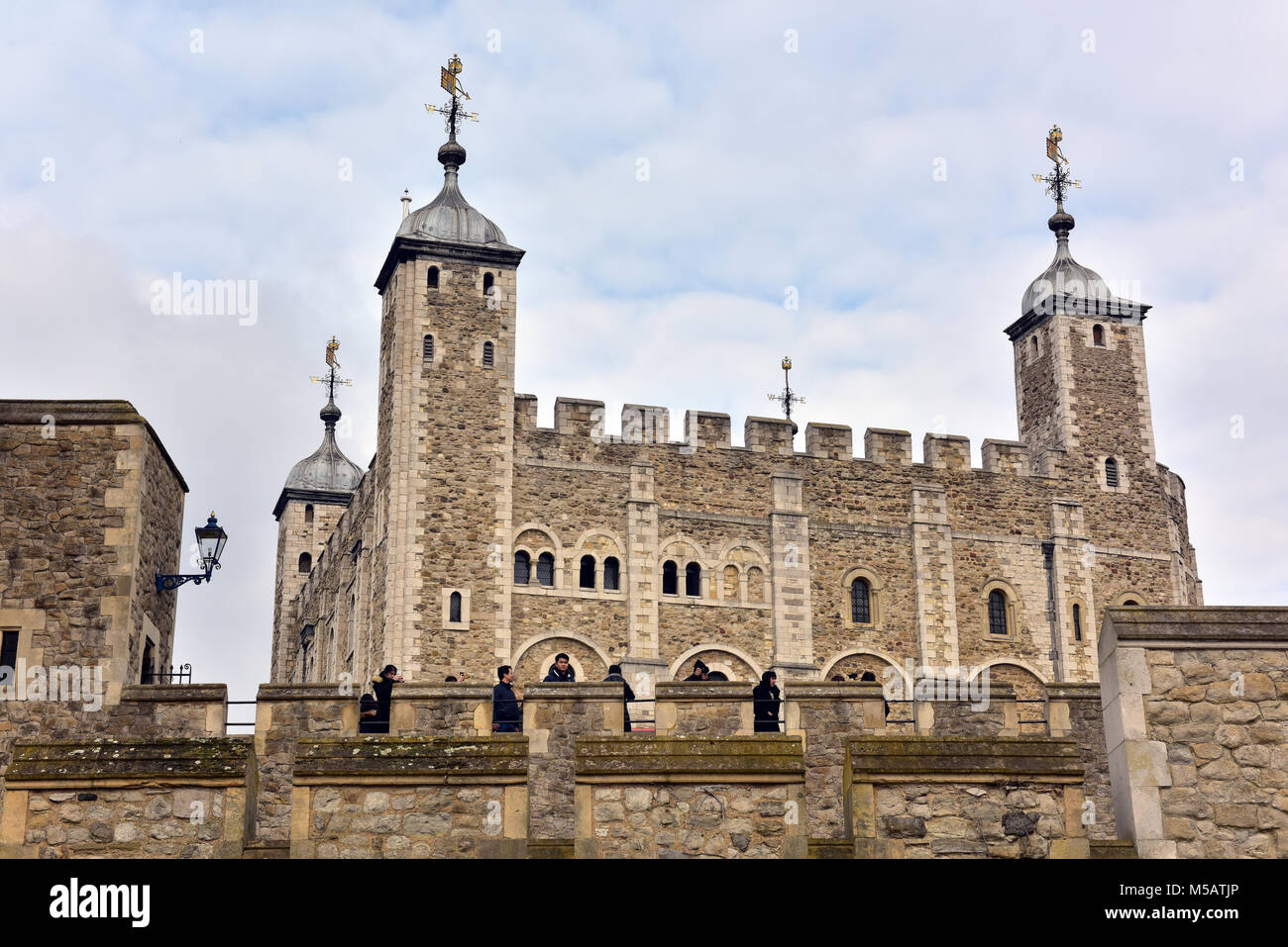 the tower of london wall facing the river thames. visitors and tourists ...