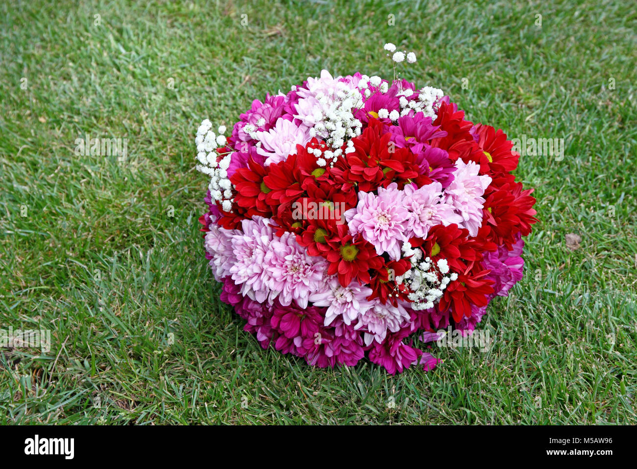 A ball of flowers on green background Stock Photo - Alamy